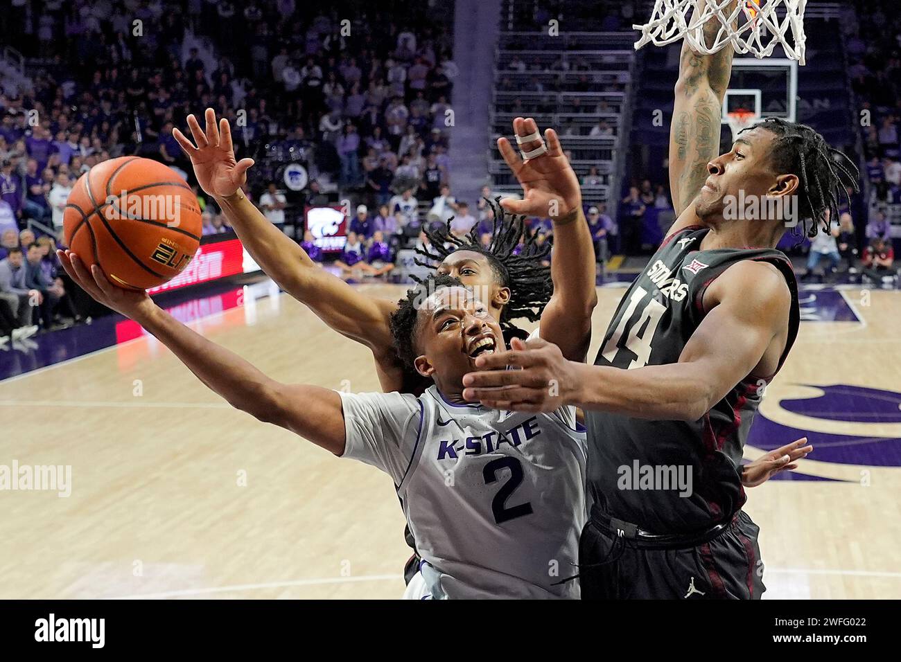 Kansas State guard Tylor Perry (2) looks to shoot under pressure from ...
