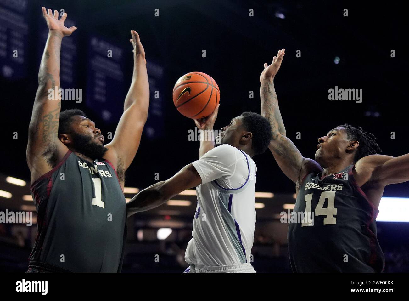 Kansas State guard Cam Carter, center, shoots under pressure from ...