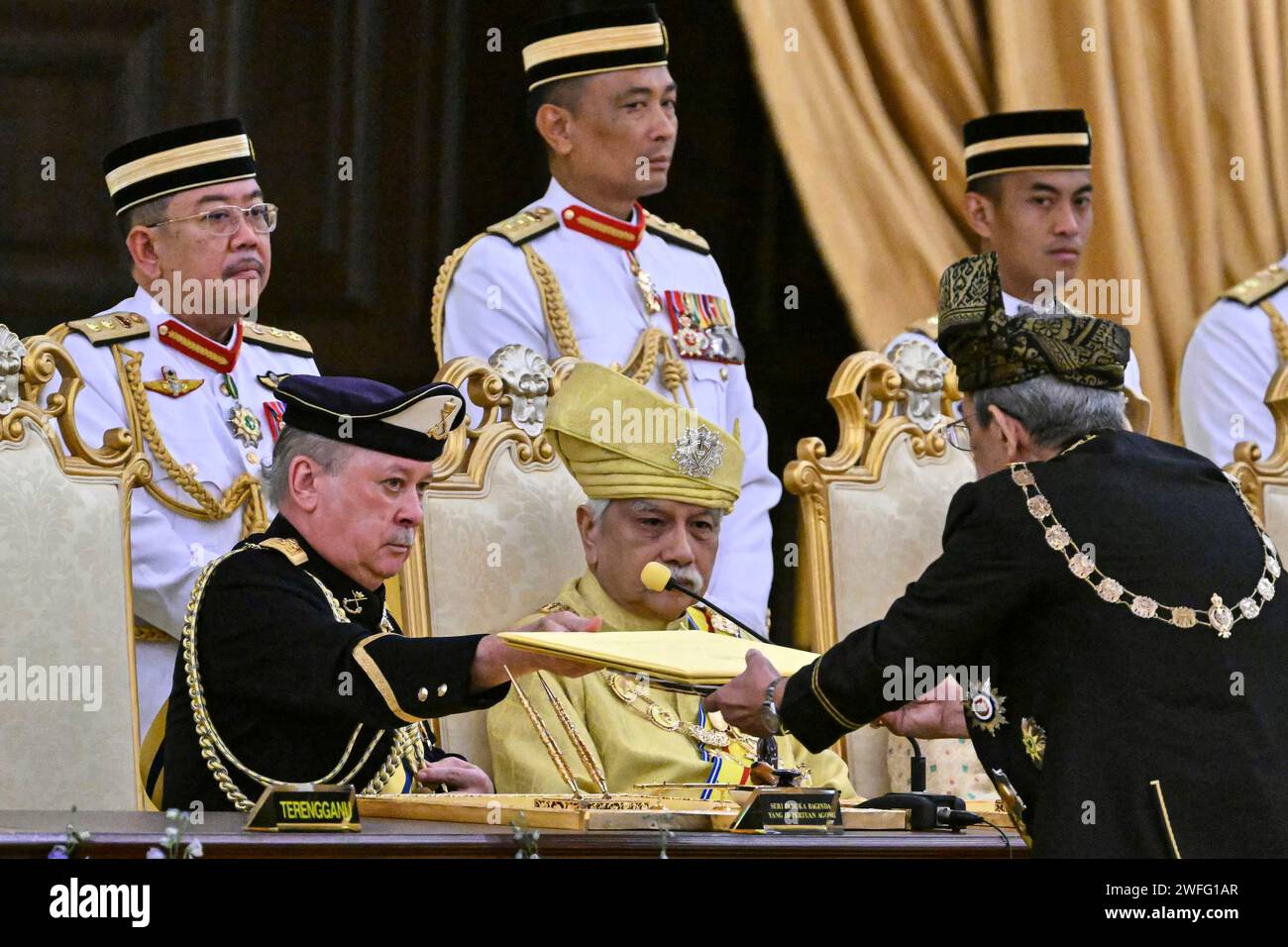 Sultan Ibrahim Sultan Iskandar, front left, receives documents during ...