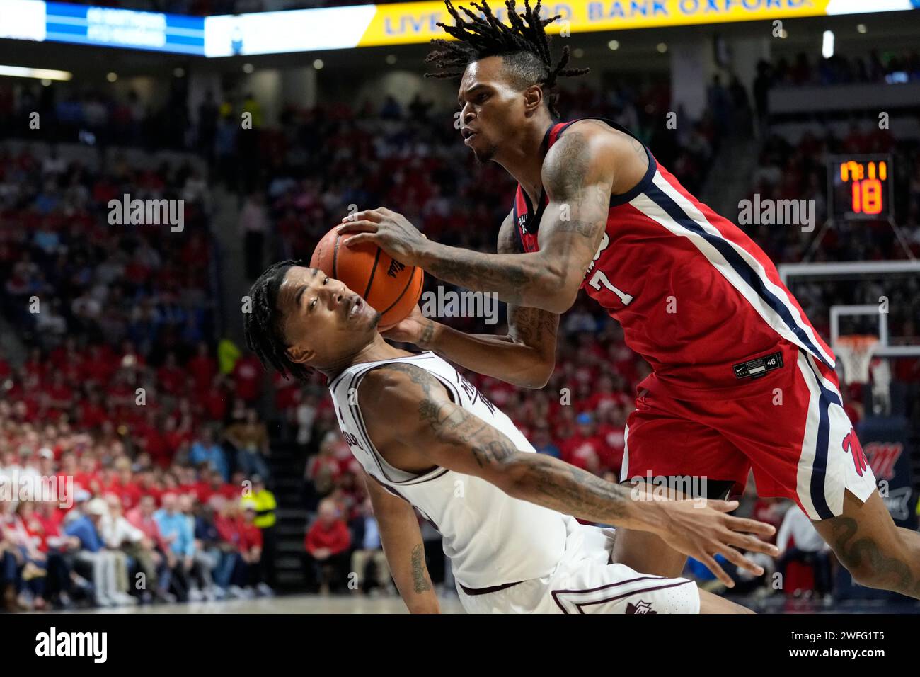 Mississippi guard Allen Flanigan (7) plows into Mississippi State guard ...