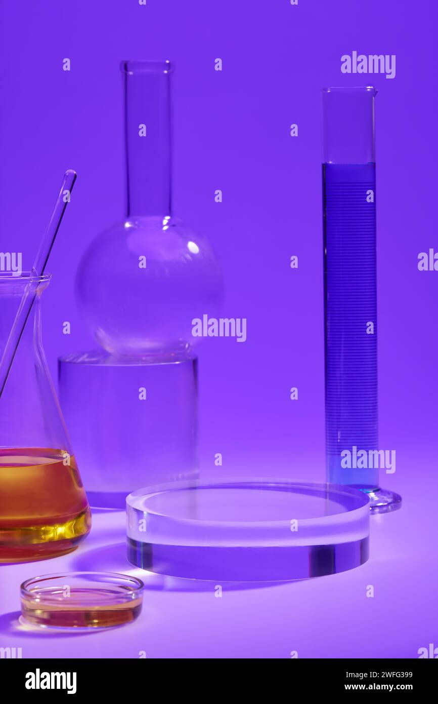Measuring cylinder of blue fluid, conical flask and petri dish of ...