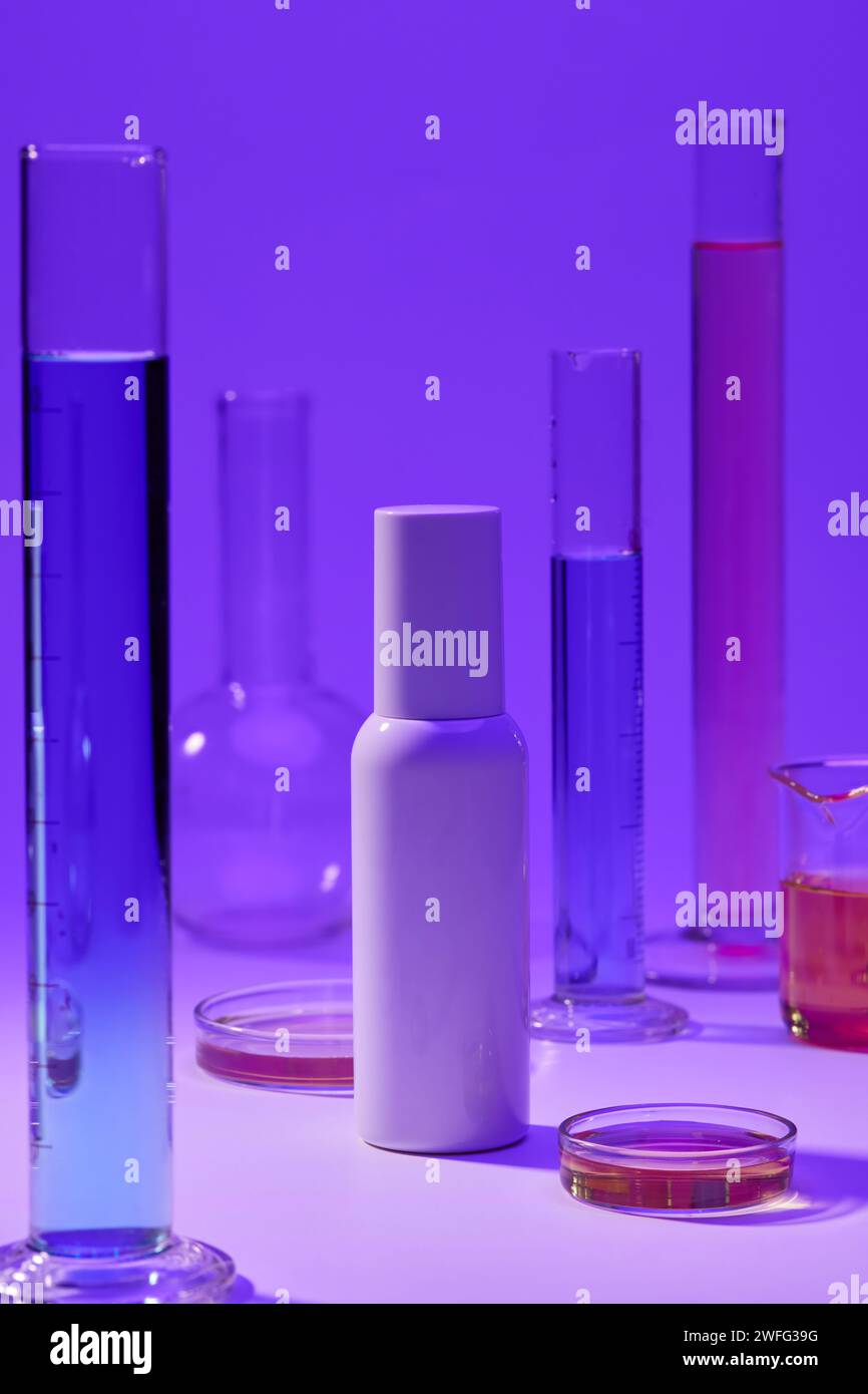 Liquid with blue and pink color contained inside measuring cylinder ...