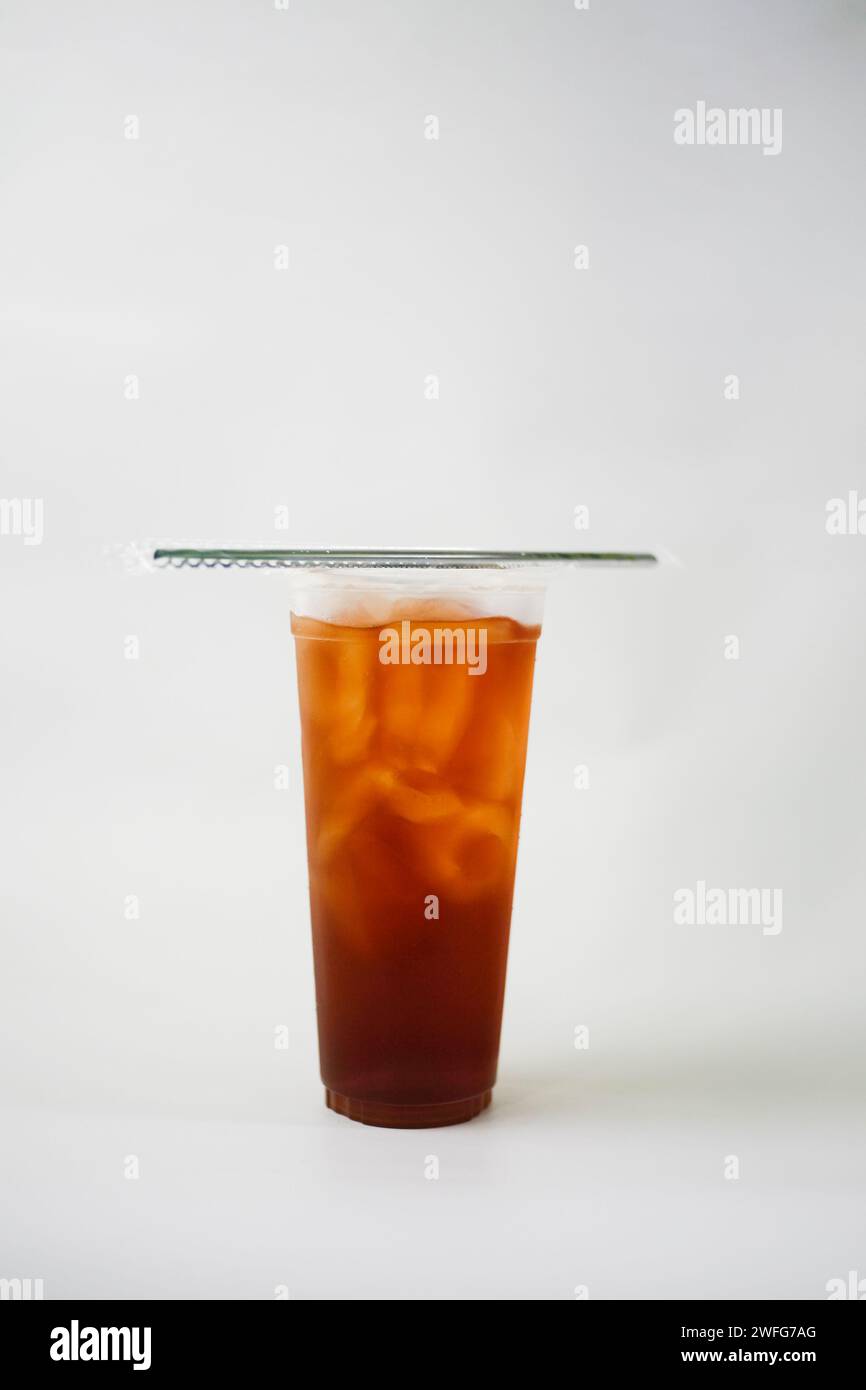 Take away iced tea in plastic cup with straw isolated in white ...