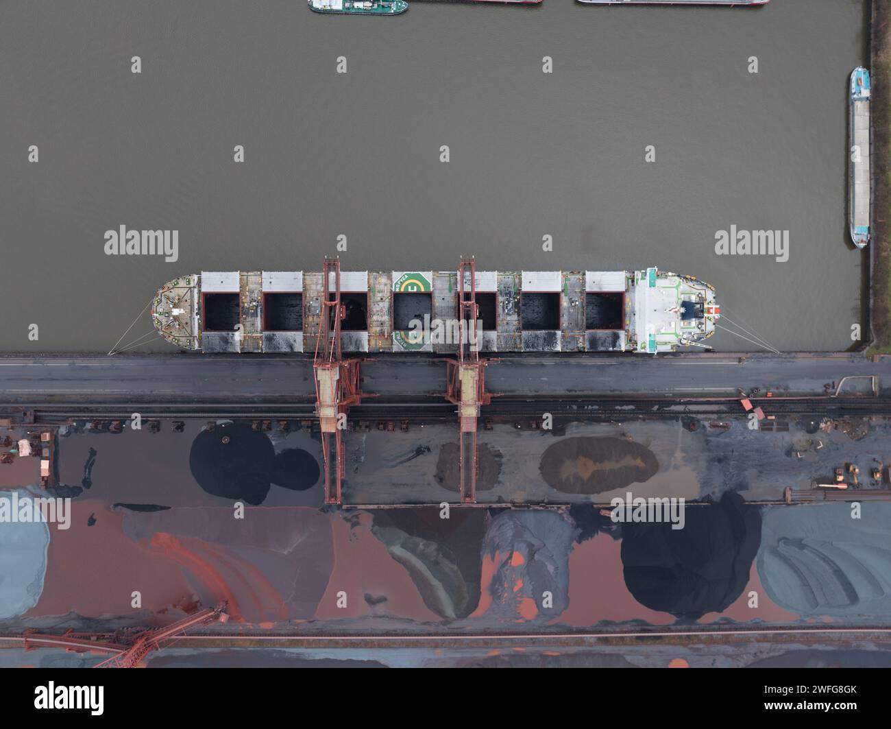Loading and unloading of raw materials in the port of Hamburg. Top down ...