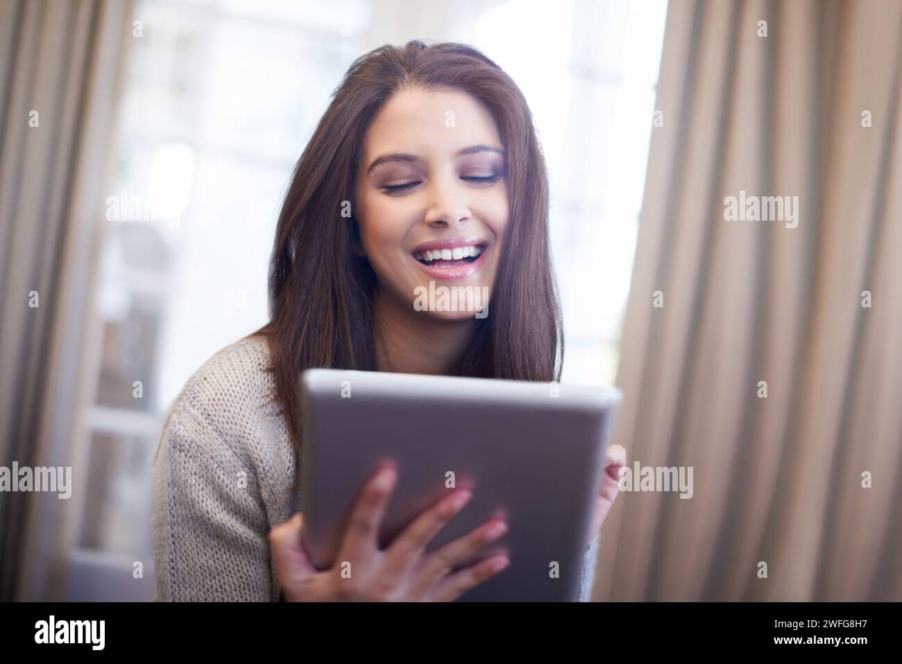 Woman, browsing and tablet for comedy and laughing, app and scrolling ...