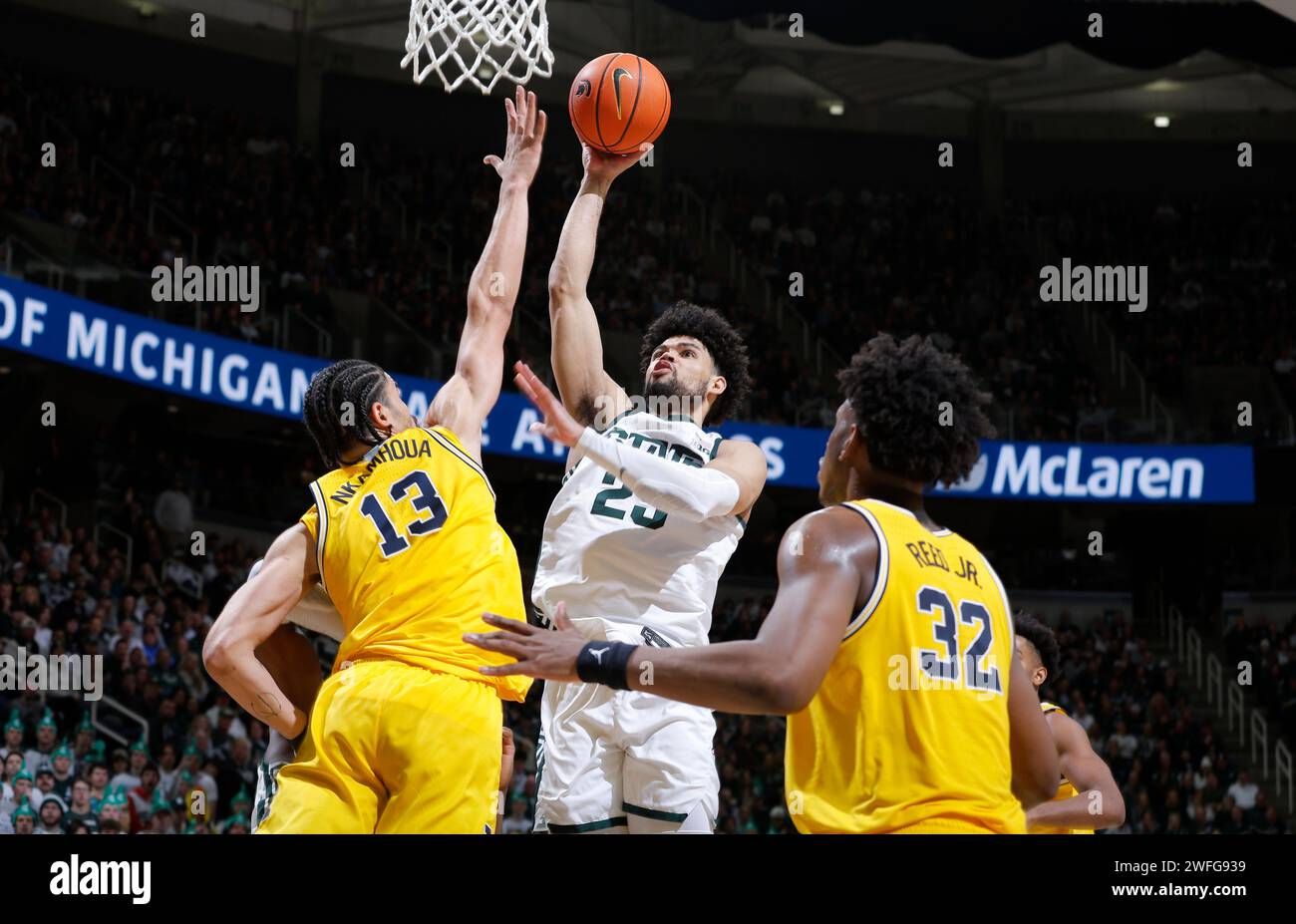 Michigan State forward Malik Hall, center, shoots between Michigan ...