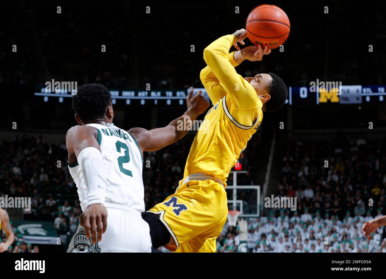 Michigan guard Jaelin Llewellyn, right, loses control of the ball as he ...