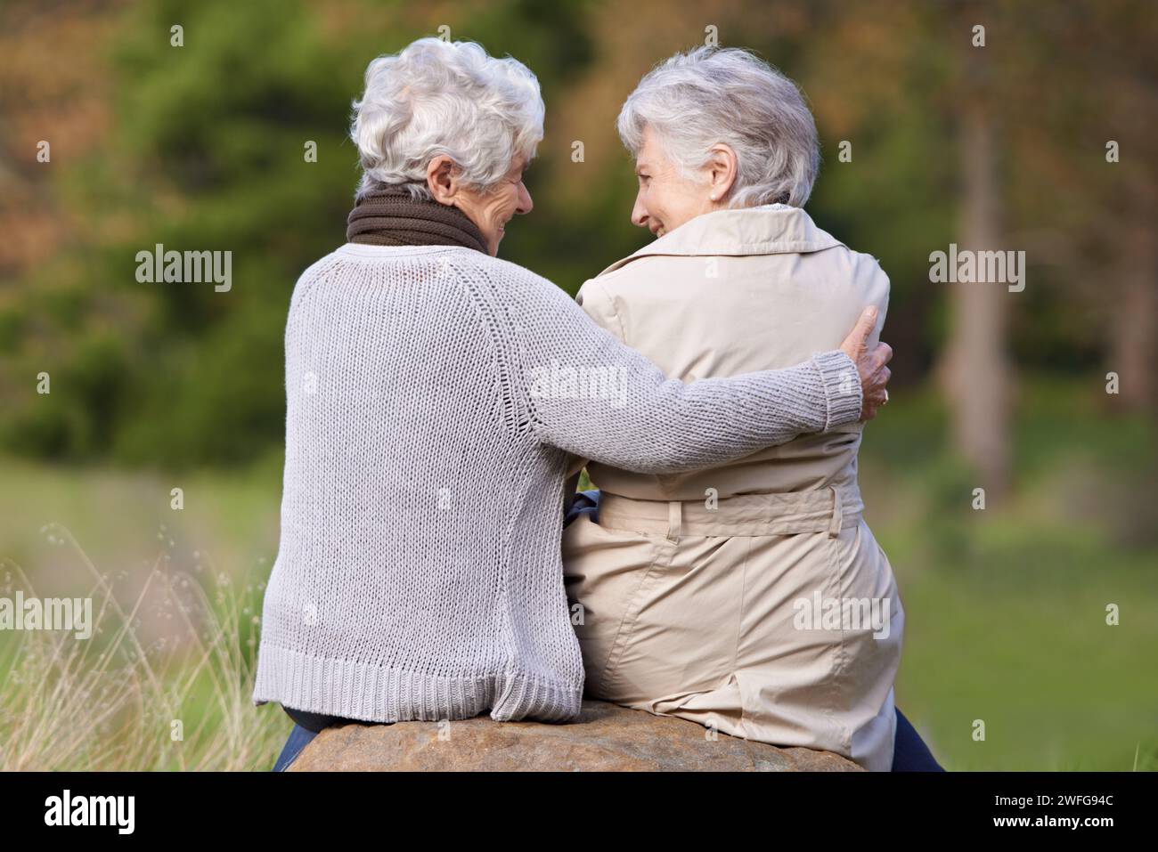 Senior friends, hug and support by outdoor in nature, together and ...