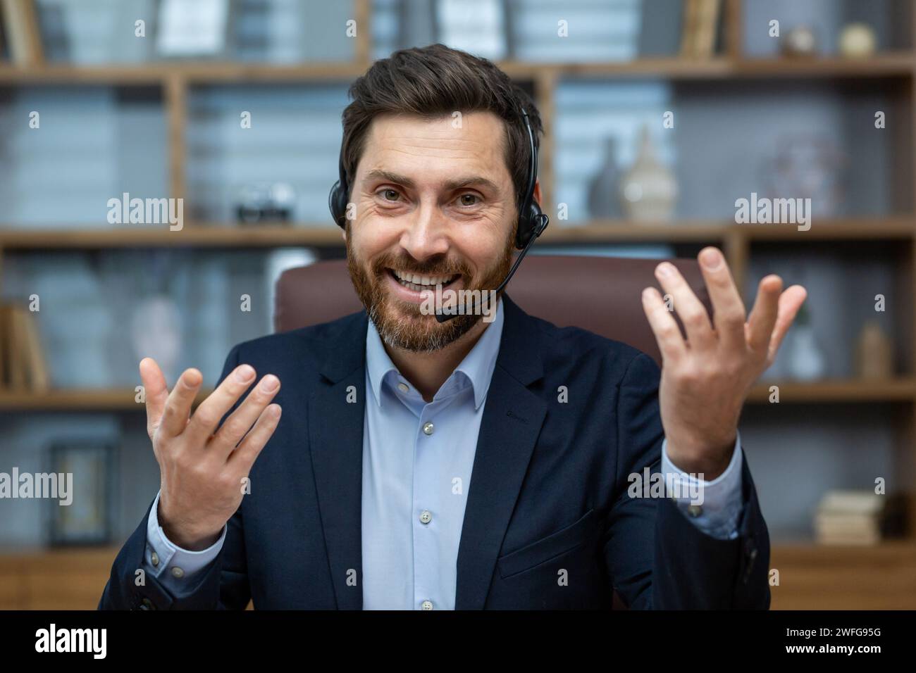 First person view of handsome man in formalwear and headset smiling ...
