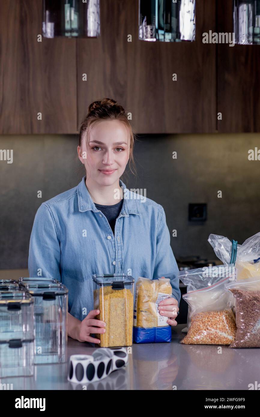 Layout and sorting of food products. Woman uses containers to organize ...