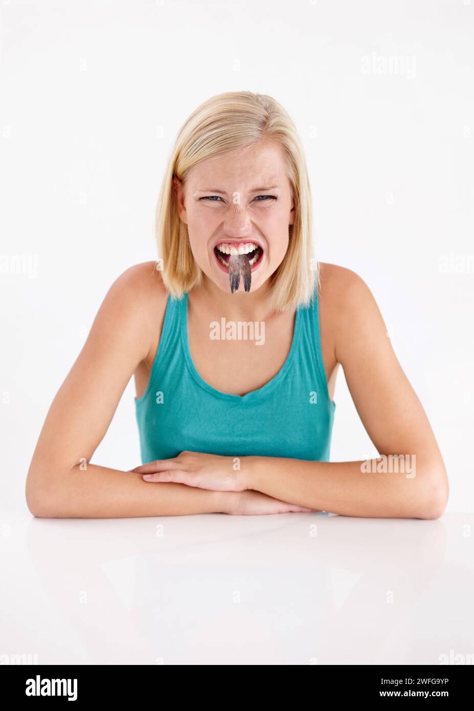 Crazy, woman and portrait of eating fish, tail or strange food in mouth ...