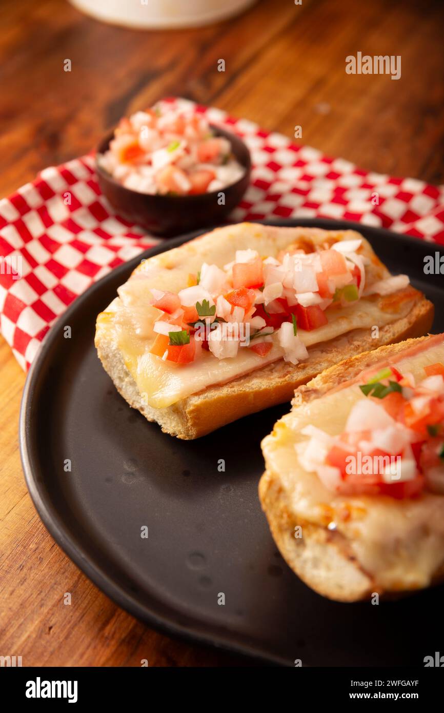 Molletes. Mexican recipe based on bolillo bread split lengthwise ...