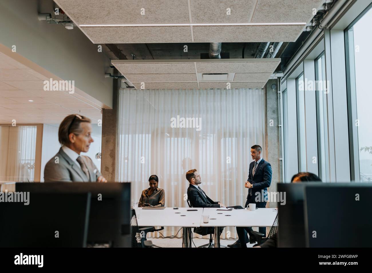 Business colleagues discussing strategy at corporate office Stock Photo ...