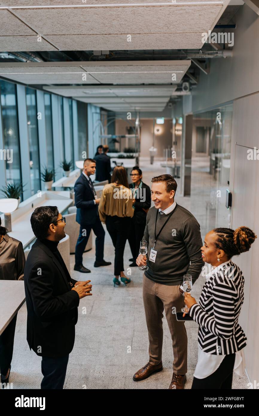 Multiracial professionals discussing during networking conference Stock ...