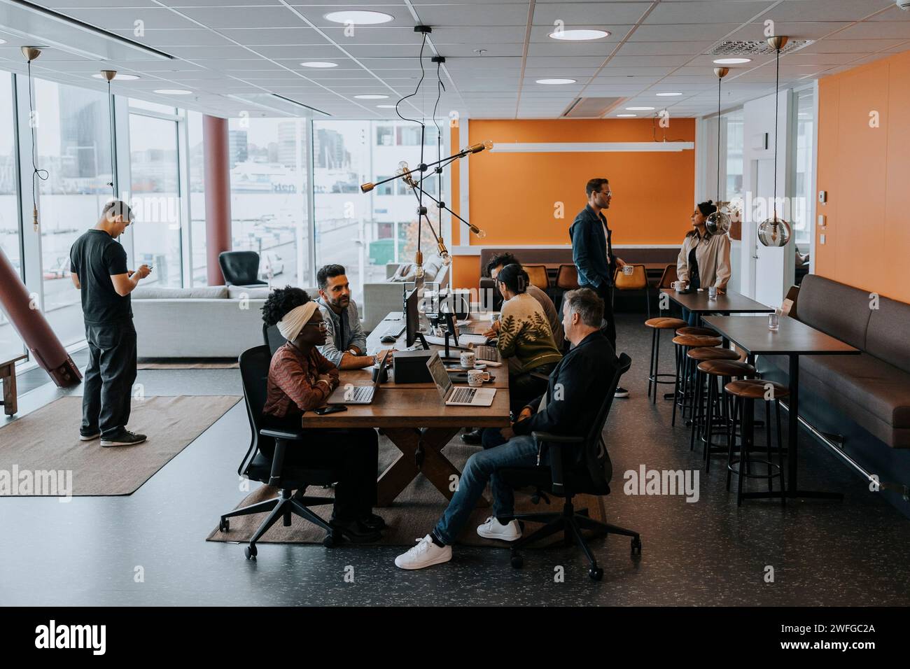 Multiracial business colleagues working in corporate office Stock Photo ...