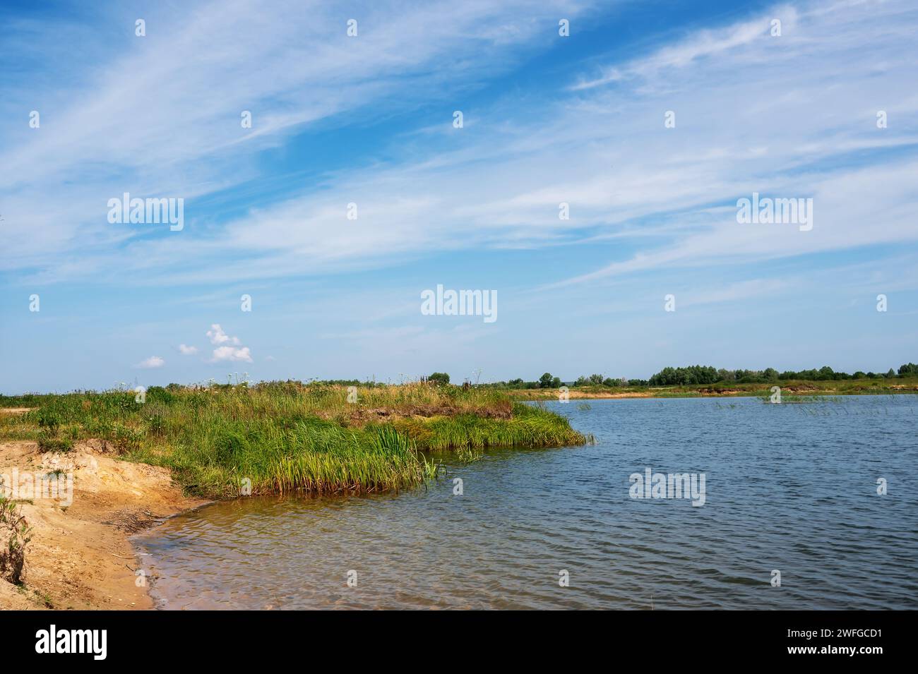 Lake Shore. Beautiful morning landscape with cirrus clouds and smooth ...
