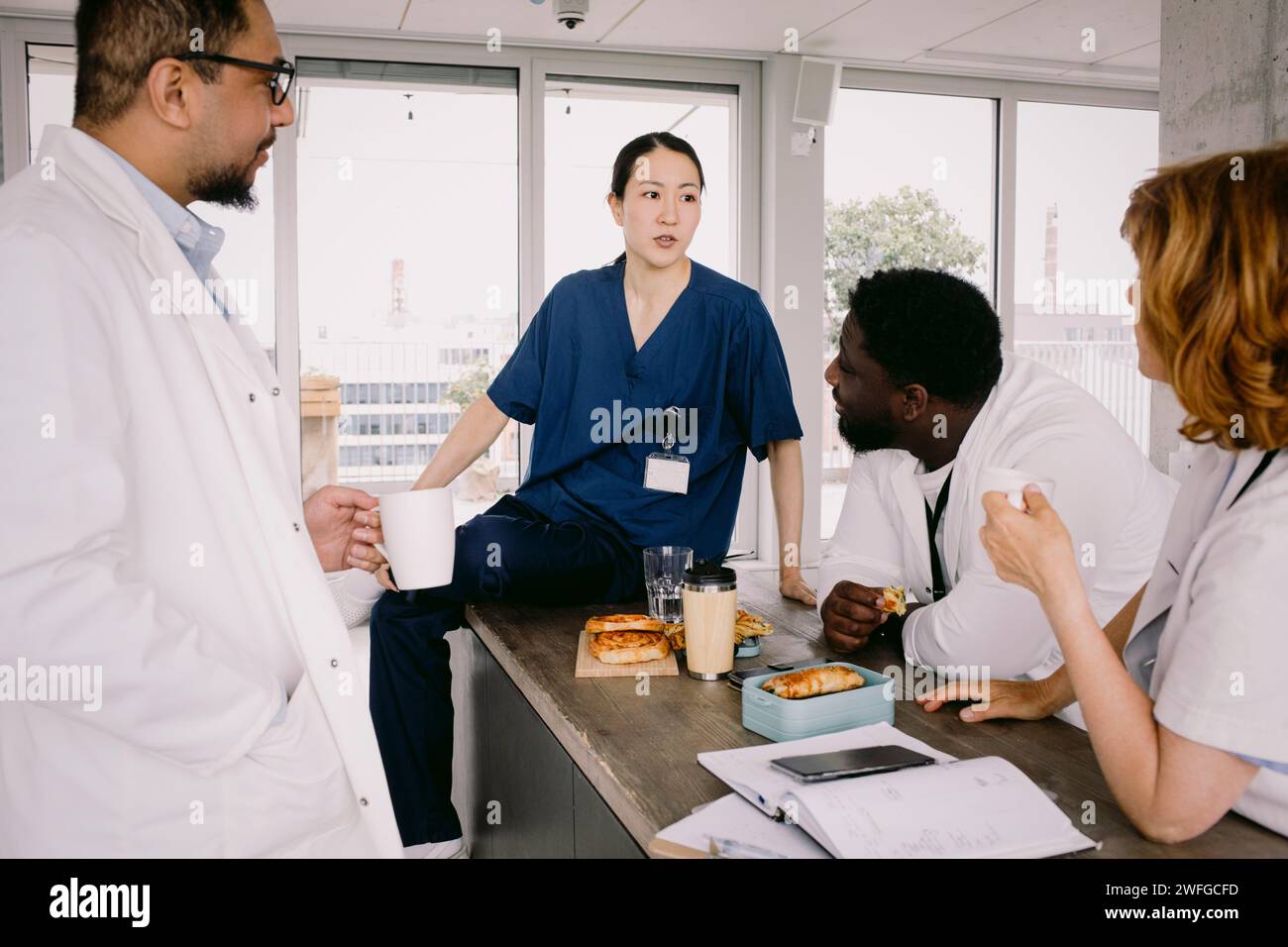 Medical colleagues discussing during lunch break at hospital Stock ...