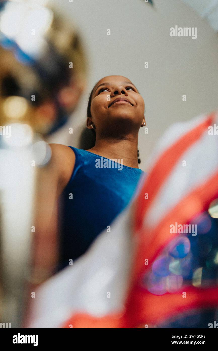 Low angle view of smiling female athlete with trophy at home Stock ...