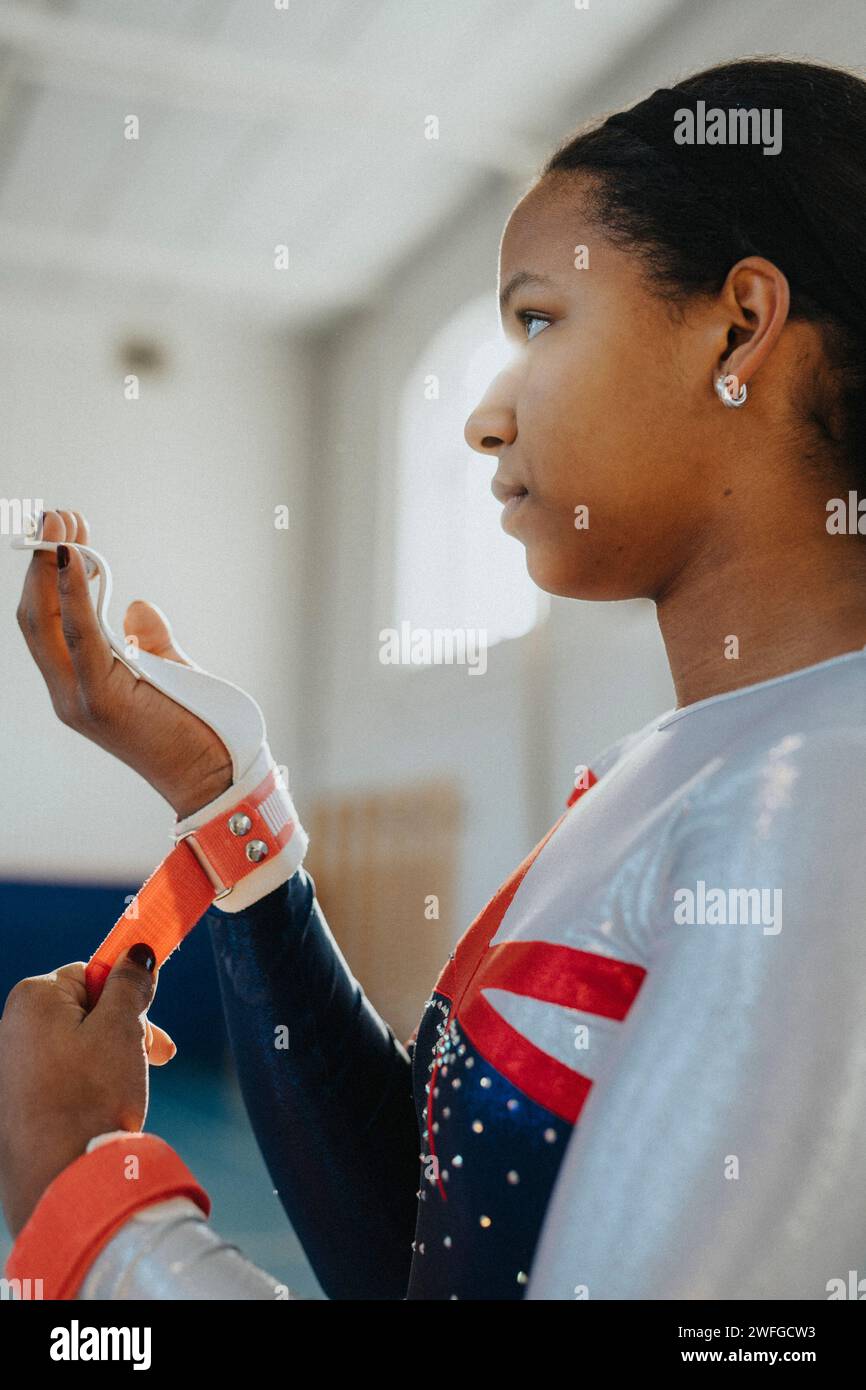 Teenage girl wearing protection band while standing in gym Stock Photo ...