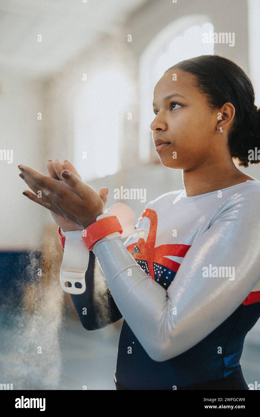 Female gymnast applying chalk powder on hands at gym Stock Photo - Alamy