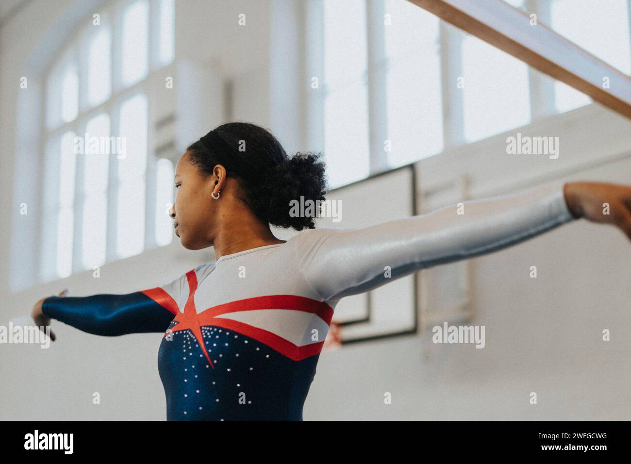 Dedicated female athlete with arm outstretched practicing exercise in ...