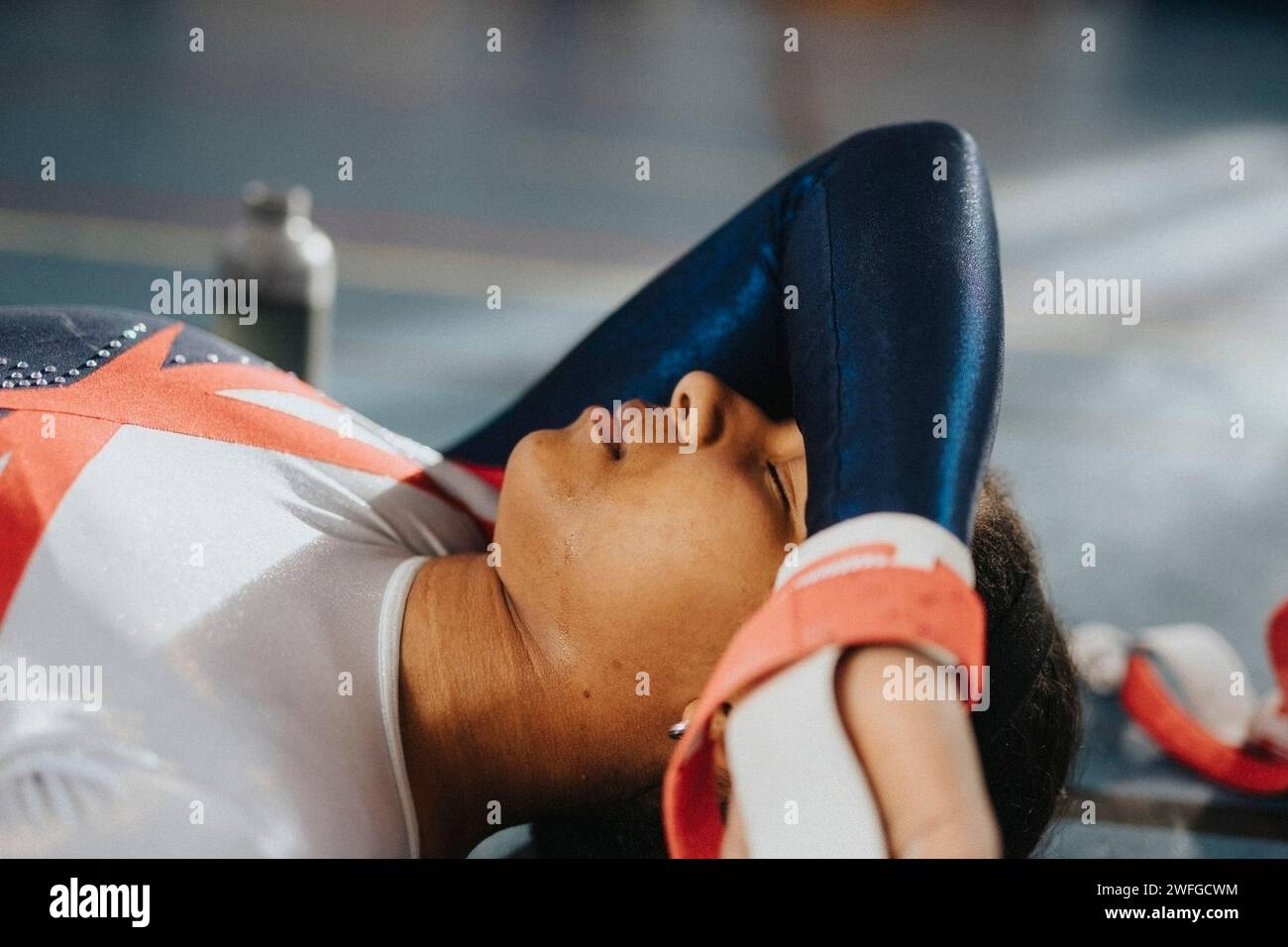 Female athlete resting on floor of gym Stock Photo - Alamy