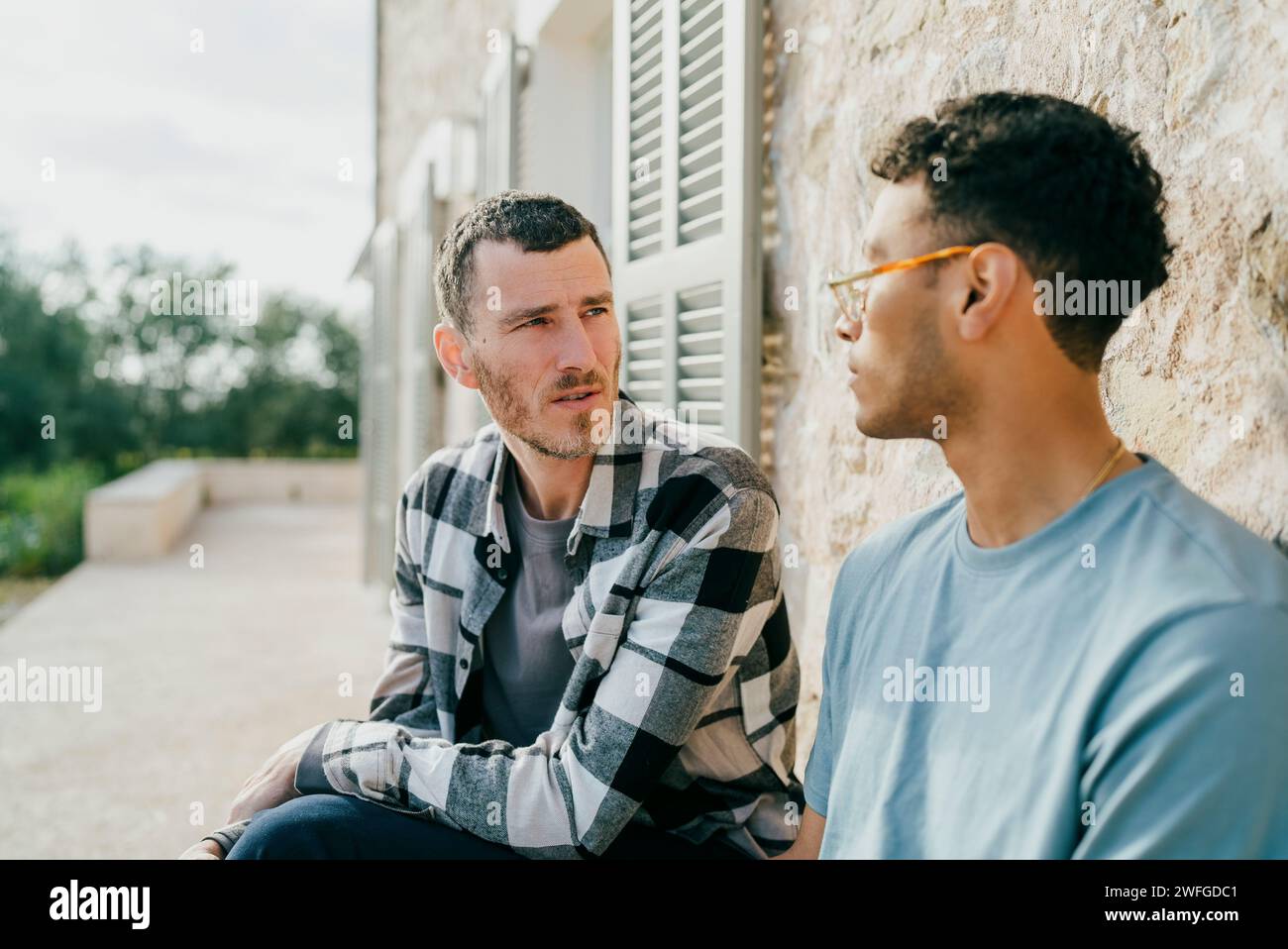 Two male friends talking outdoors hi-res stock photography and images ...