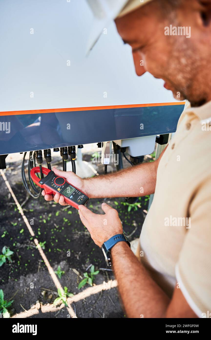 Engineer Checking Output Voltage Level Of Solar Inverter Professional Worker Checking Voltage