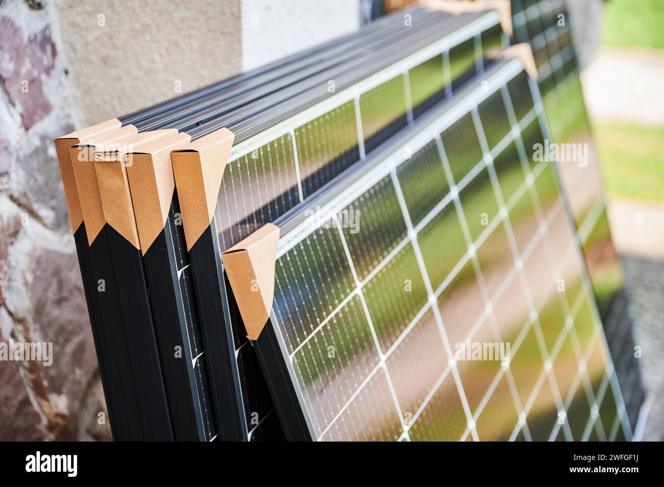 Close-up new solar panels with protective cardboard corners, ready for ...