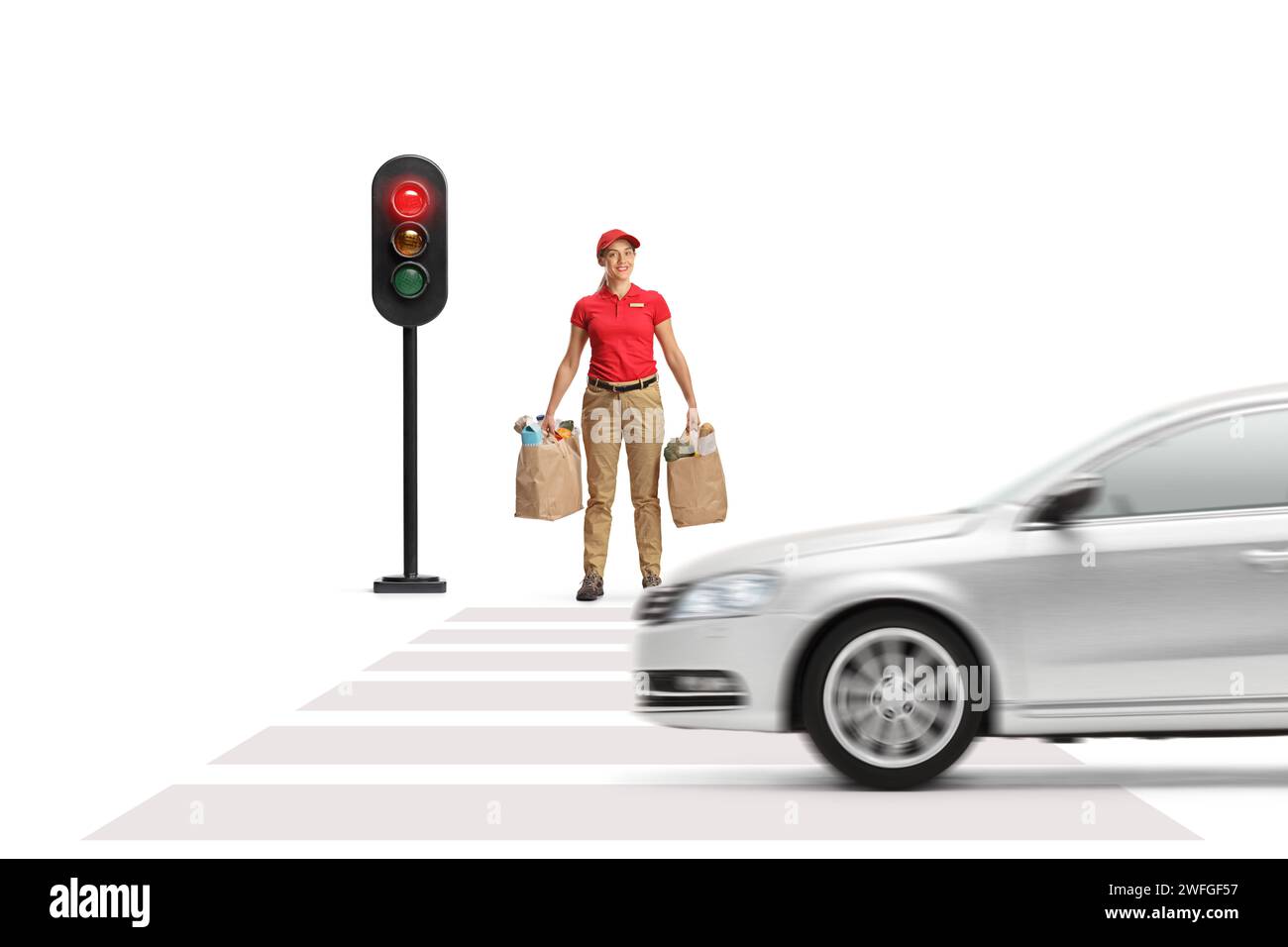 Full length portrait of a delivery woman holding bags with groceries ...