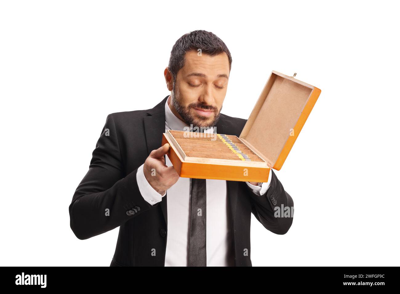 Happy young man smelling a box of cigars and smiling isolated on white ...