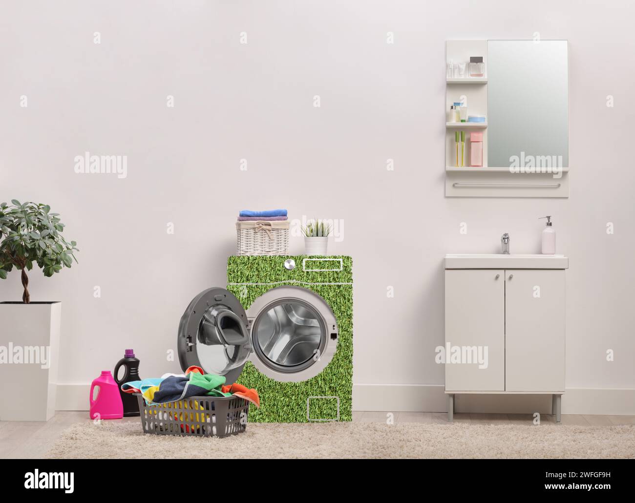 Green sustainable washing machine inside a bathroom Stock Photo - Alamy