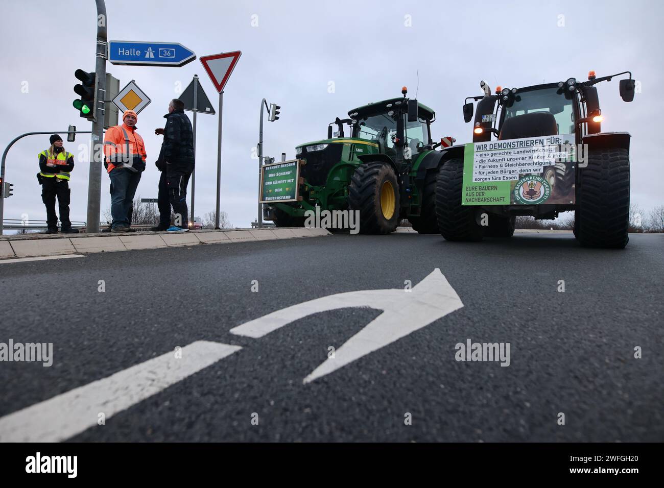 Wernigerode, Germany. 31st Jan, 2024. Farmers stand with tractors at ...