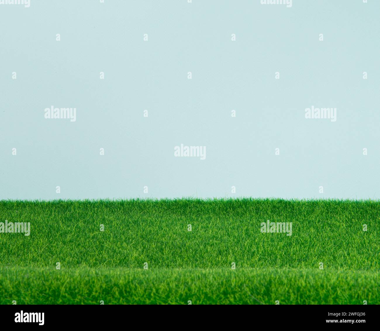 Studio grass and blue background for mockup Stock Photo - Alamy