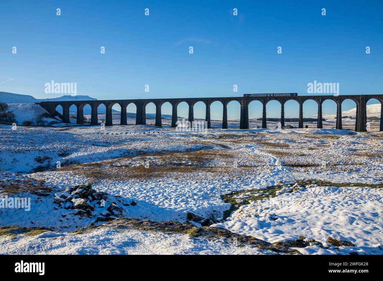 A Northern rail train crossing the famous Ribblehead Viaduct on a wintery day in the Yorkshire ...