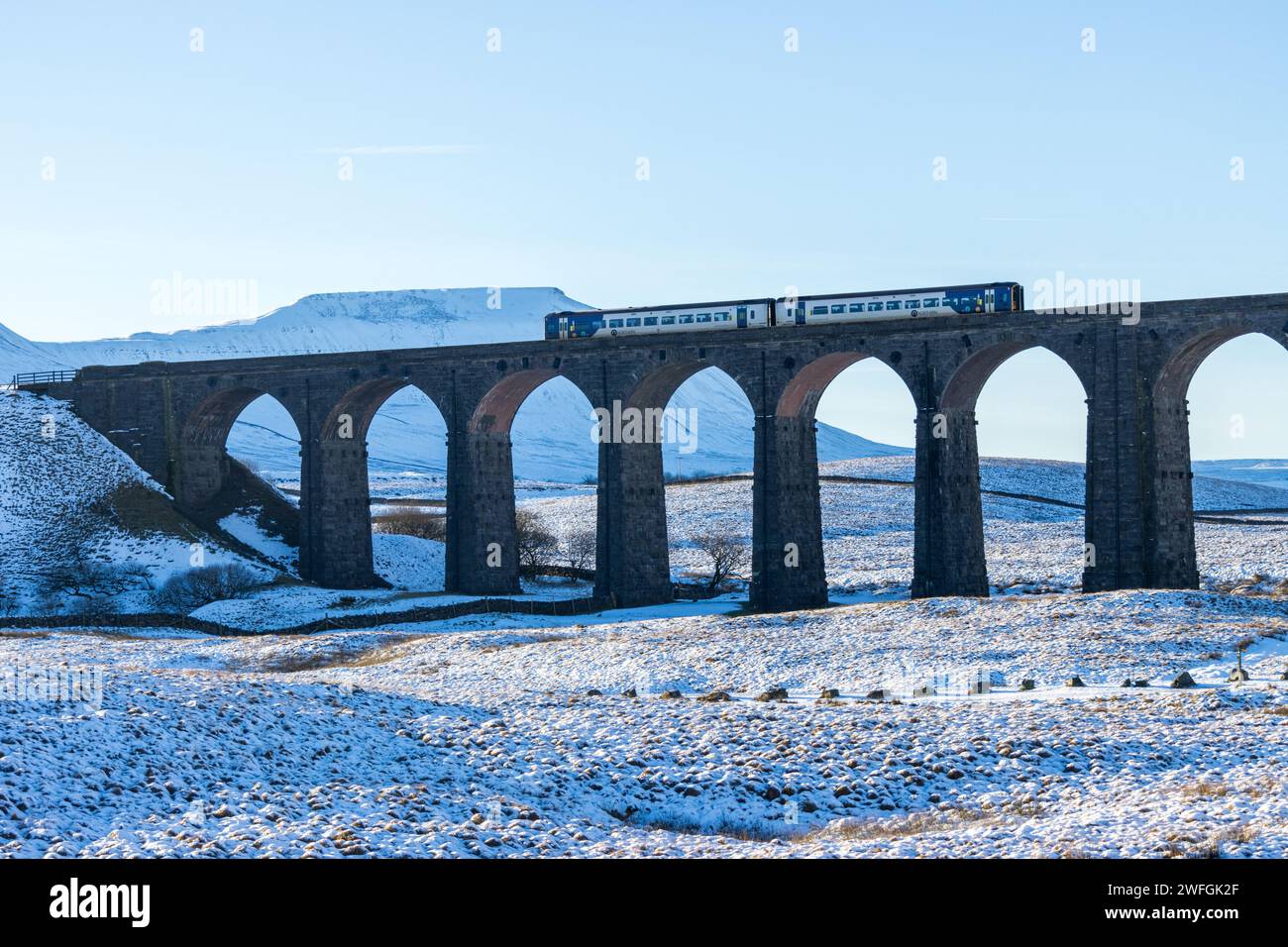 A Northern rail train crossing the famous Ribblehead Viaduct on a wintery day in the Yorkshire ...