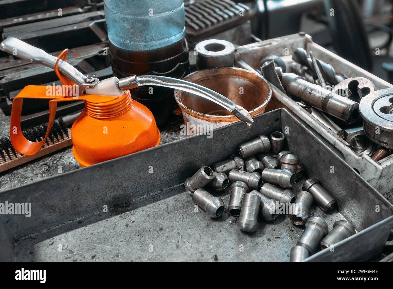 Metal turning shop. Metal fittings are in tray. Turning metal parts on ...