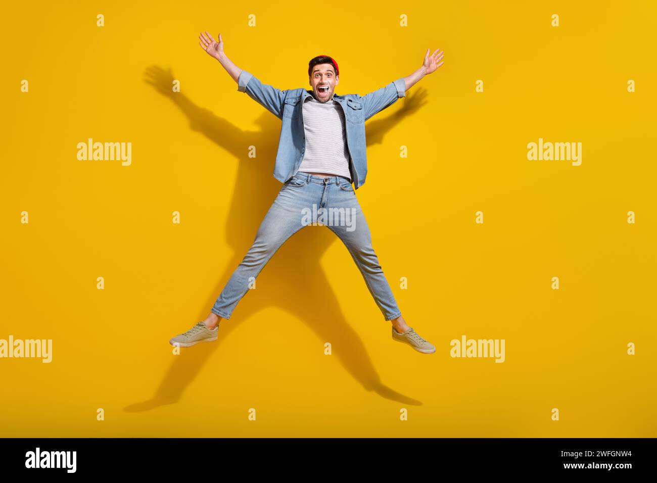 Full length photo of excited good mood guy wear denim jacket jumping ...