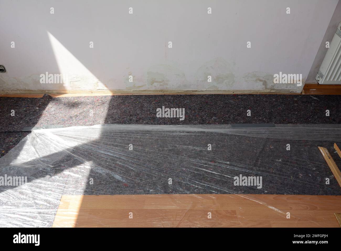 A room in an apartment during renovation with the floor taped off to ...