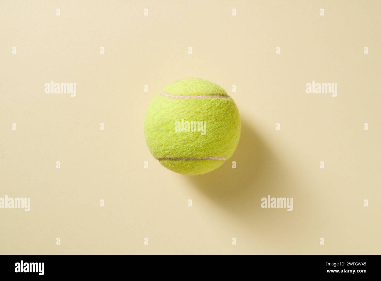 Top view of tennis ball on yellow background Stock Photo - Alamy