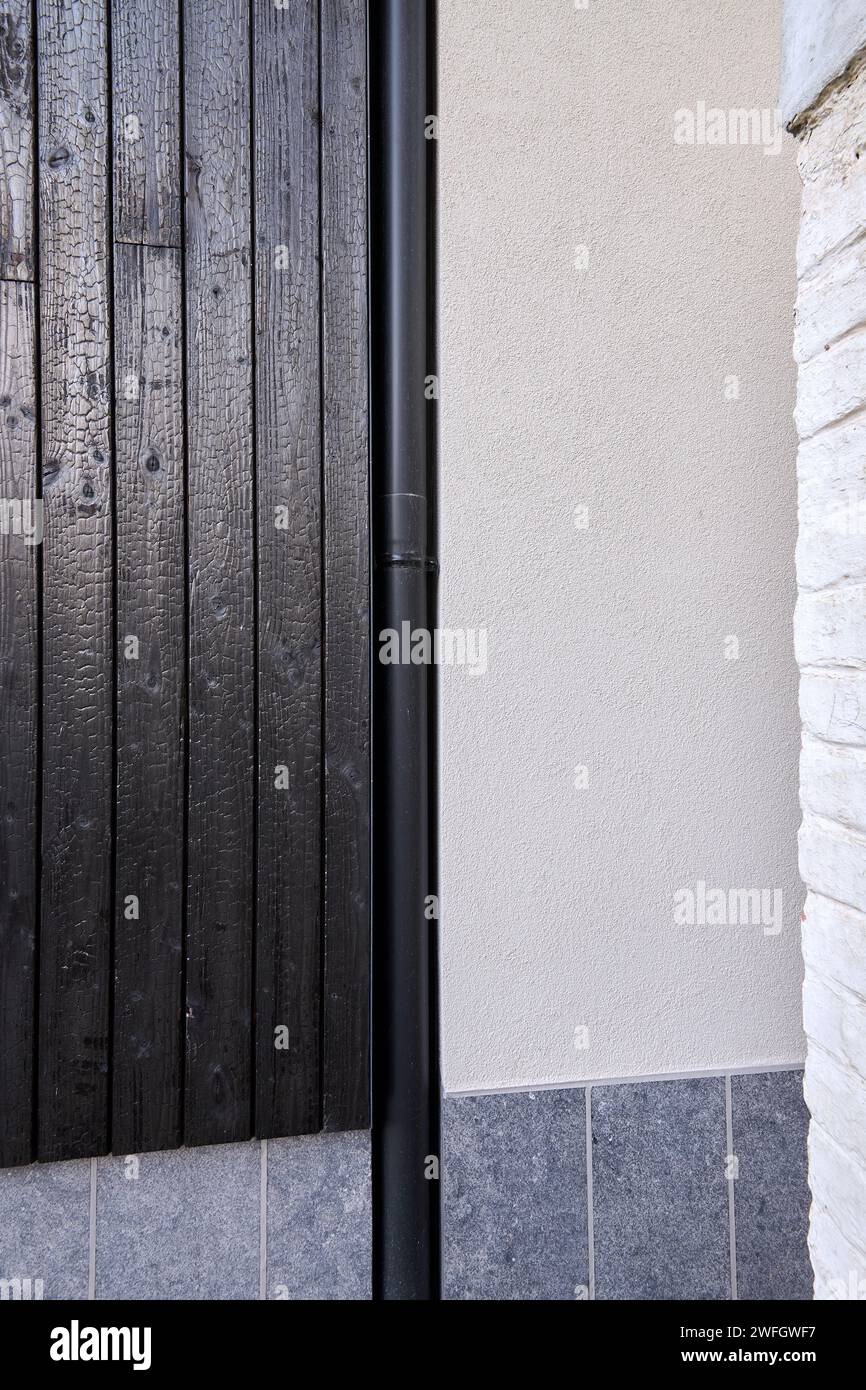 Modern rain gutter on burned wood wall Stock Photo - Alamy