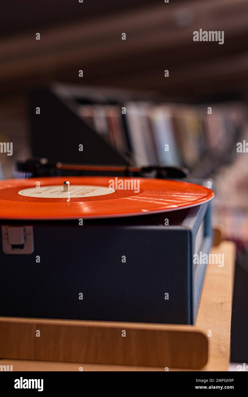 A vinyl record player on the background of a music store window ...