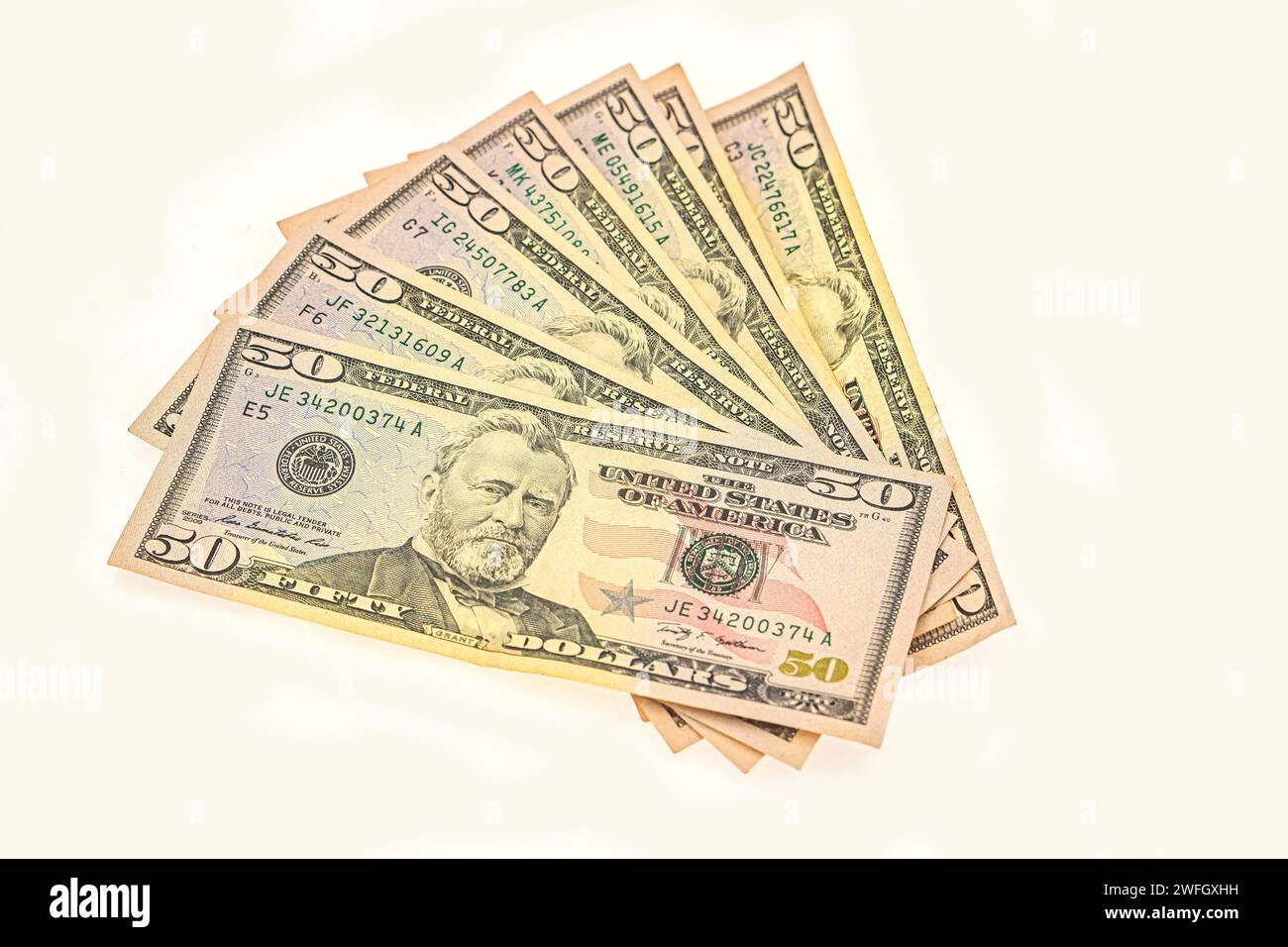 Fifty 50 dollar bills fanned out on a white background. Lots of 50 ...