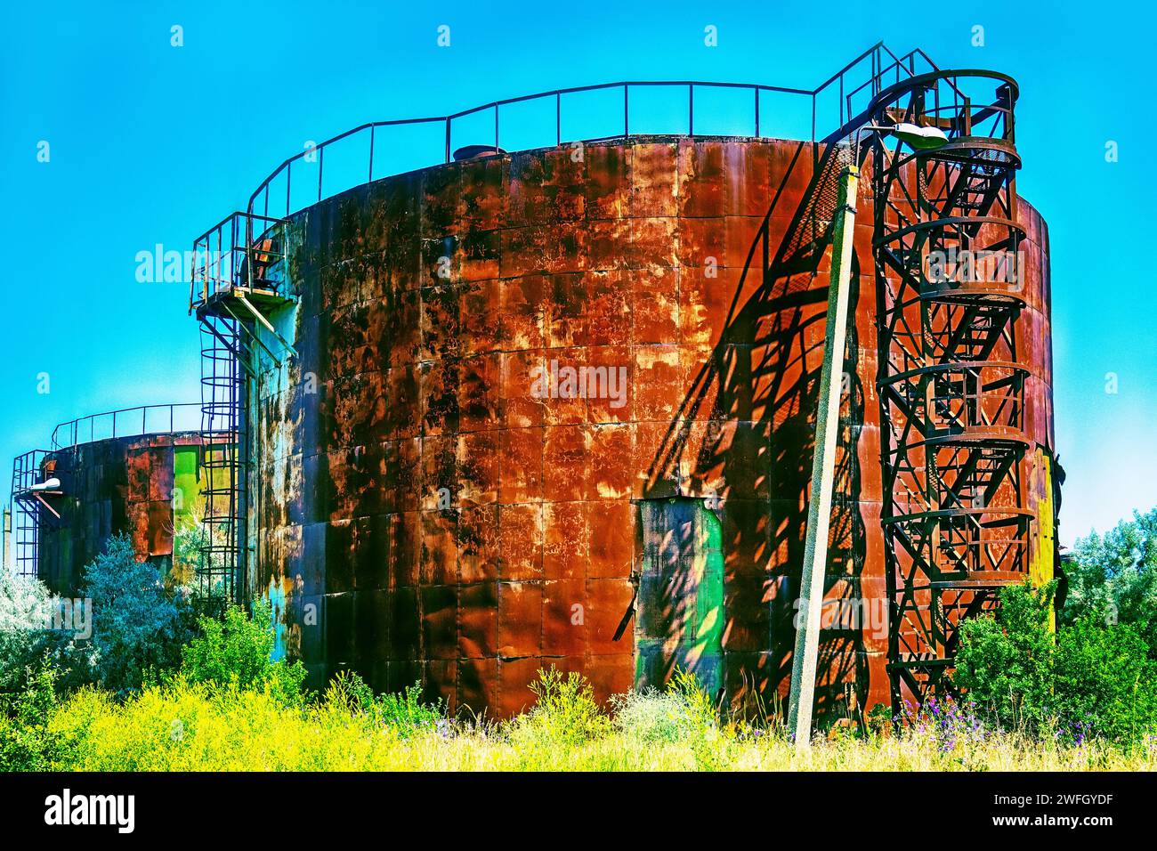 Old rusty oil tanks (fuel reservoir, oil barrel). Evidence of economic ...