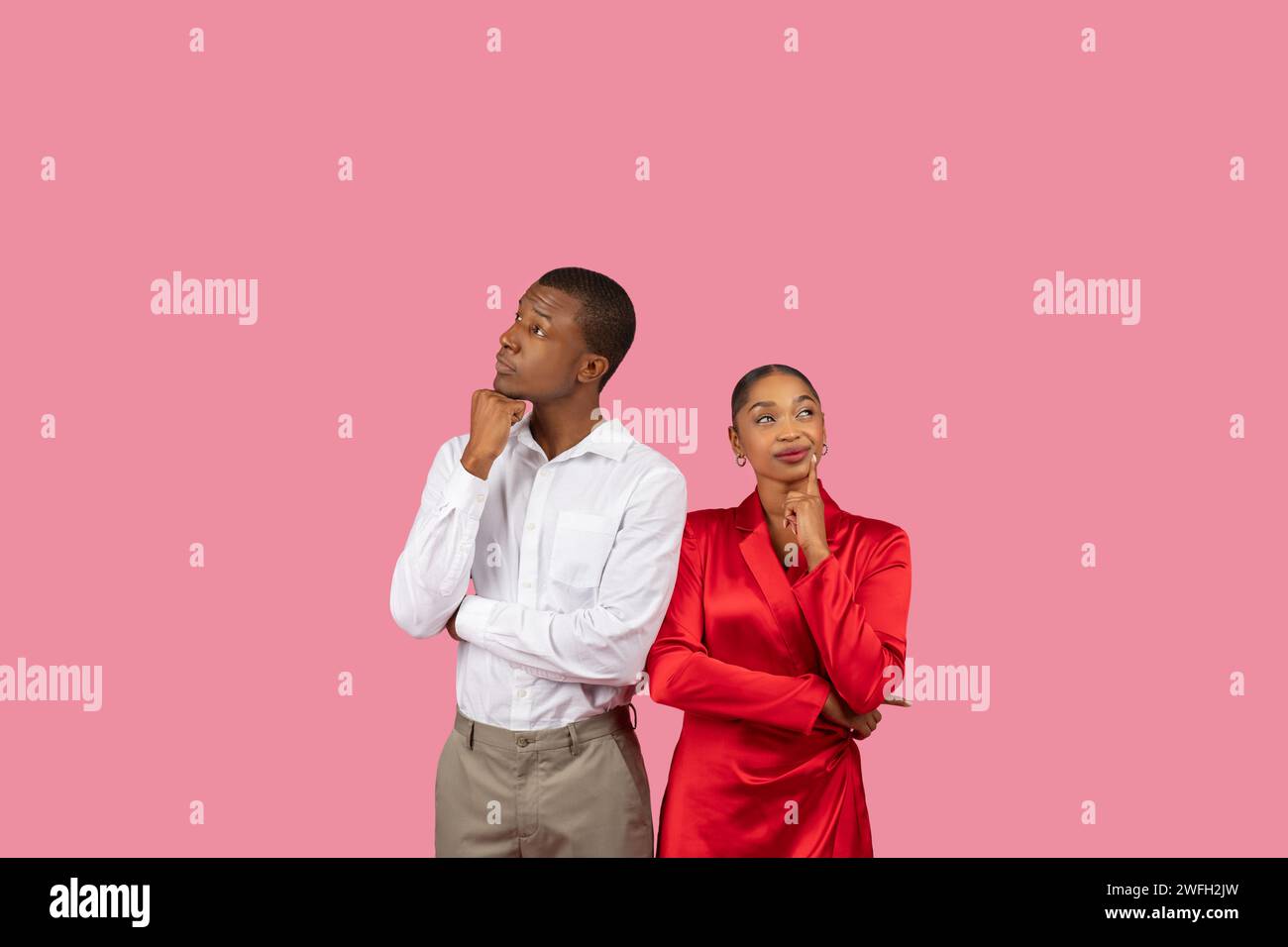 Thoughtful black couple in white and red with curious poses Stock Photo ...