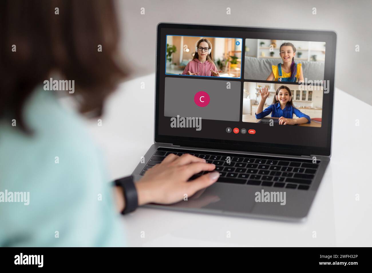 Teacher with computer having video conference chat with class Stock ...