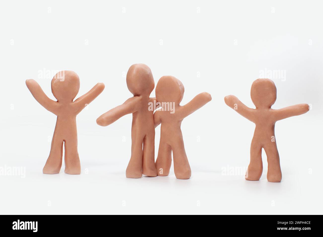 clay figures holding each other Stock Photo - Alamy