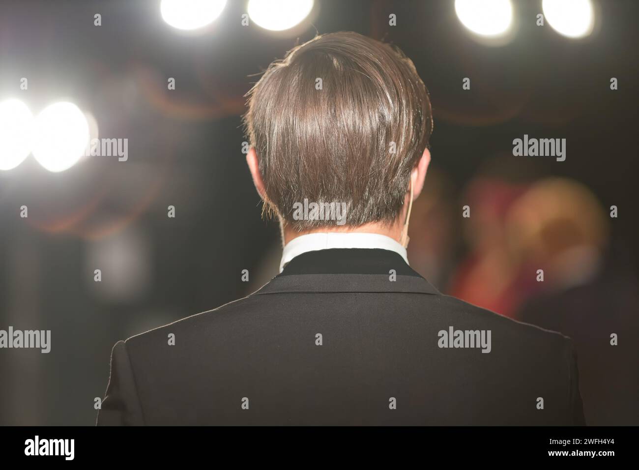 actor performing on stage with spot lights Stock Photo - Alamy