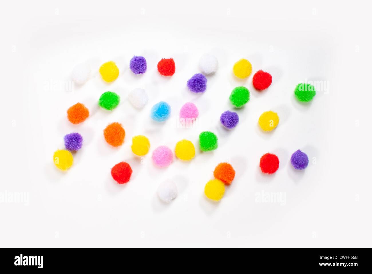 fluffy round colorful balls isolated on white surface Stock Photo - Alamy