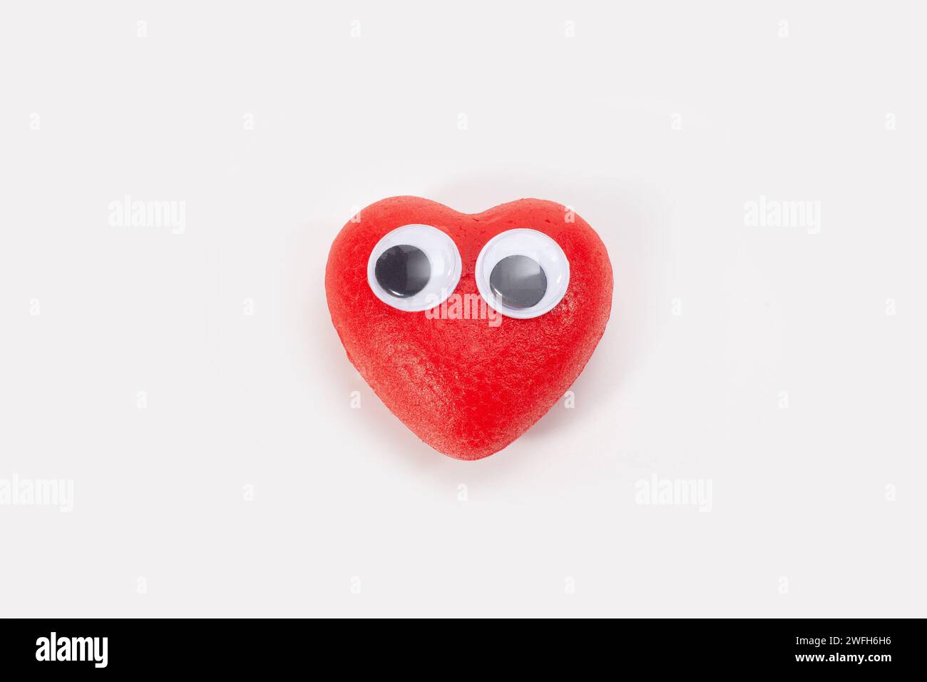 small red heart with eyes isolated on white background Stock Photo - Alamy